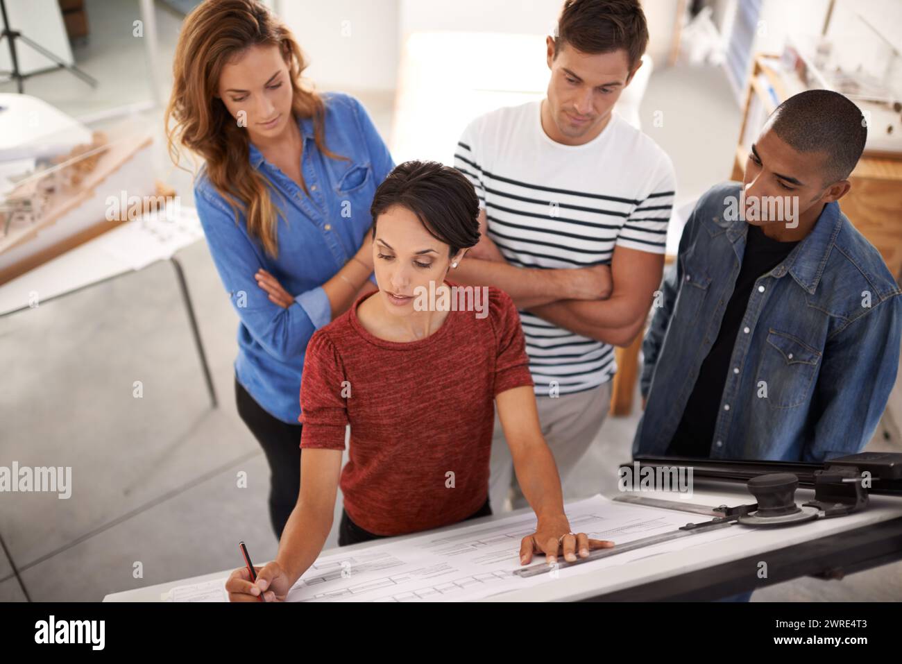 Team, drawing and architects with blueprint for training, construction ...