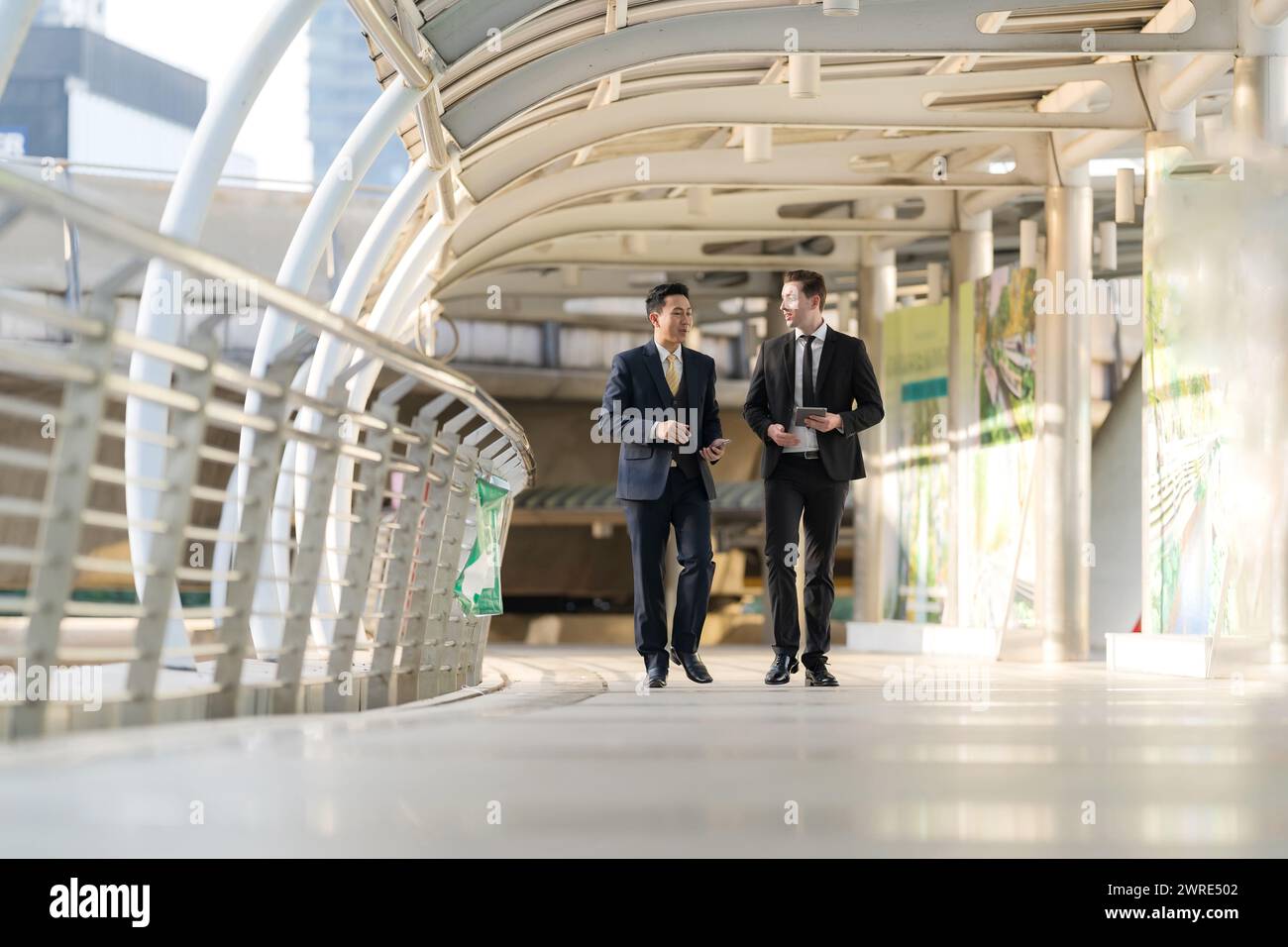 Business people walking and talk to each other in front of modern ...