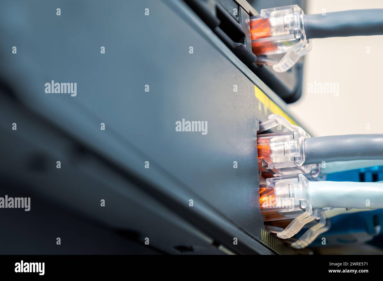 Network Gigabit Smart PoE Switch with connected network cables getting ...