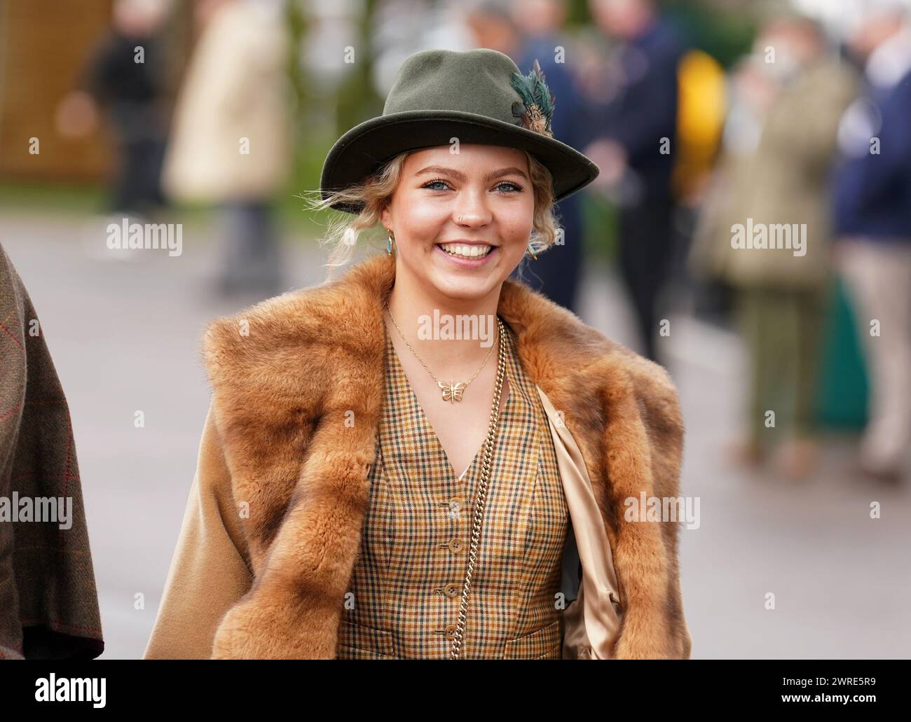 A racegoer arriving on day one of the 2024 Cheltenham Festival at ...