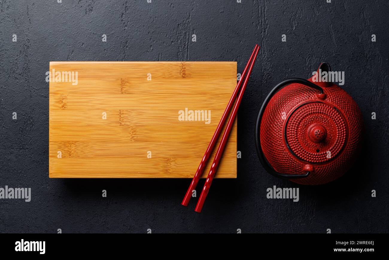 Japanese Table Setting with Wooden Board, Teapot, Chopsticks, and Copy ...