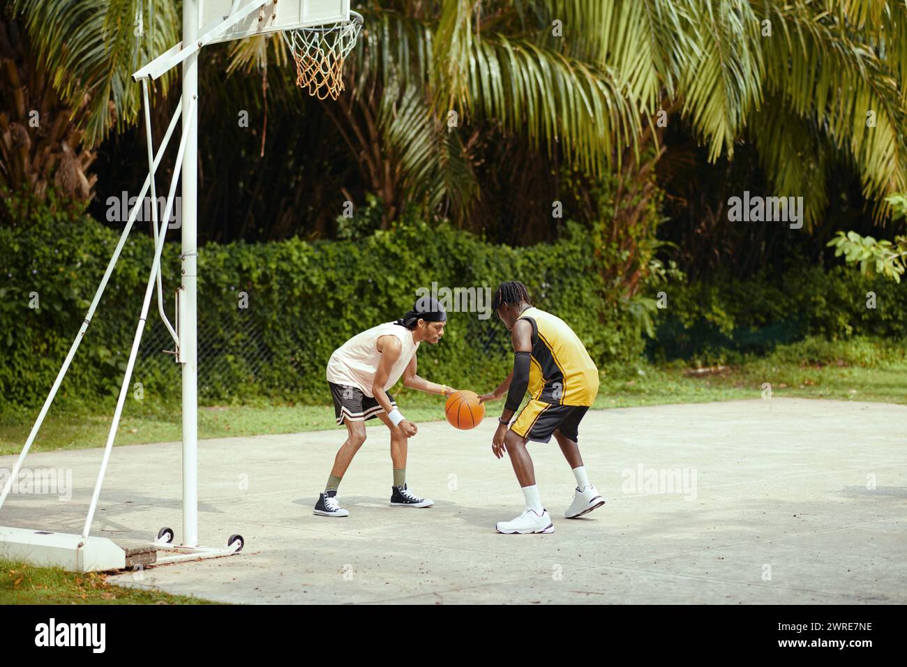 Active Black men playing street ball on weekend afternoon Stock Photo ...