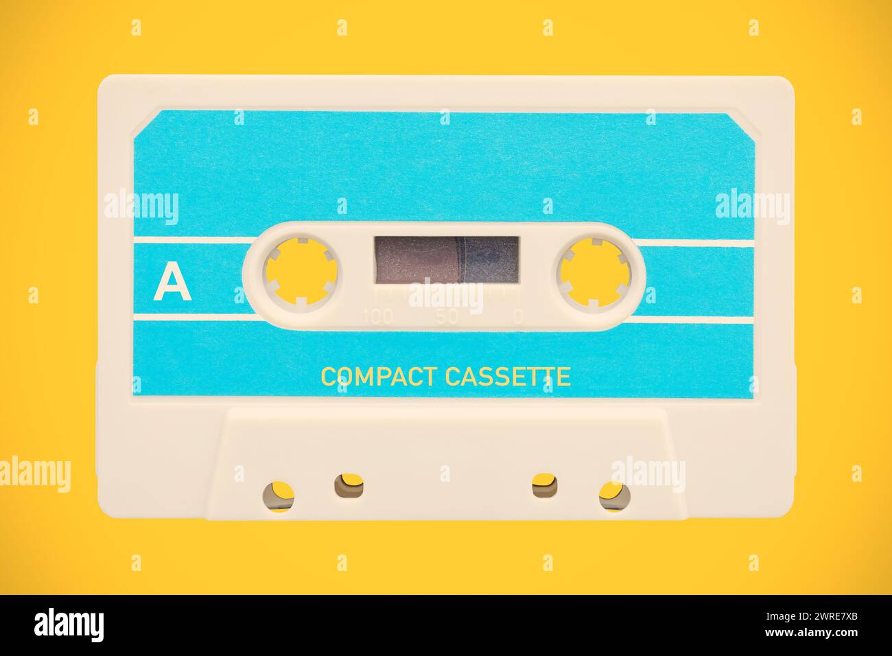 Vintage blue with white audio compact cassette in front of an orange ...