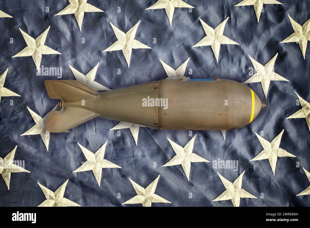 Ancient military missile bomb in front of the stars of an American flag ...
