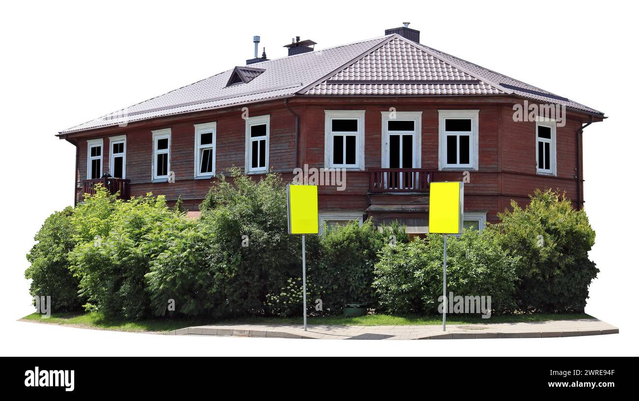 Dense bushes grow in front of an old aged wooden house. Isolated on ...
