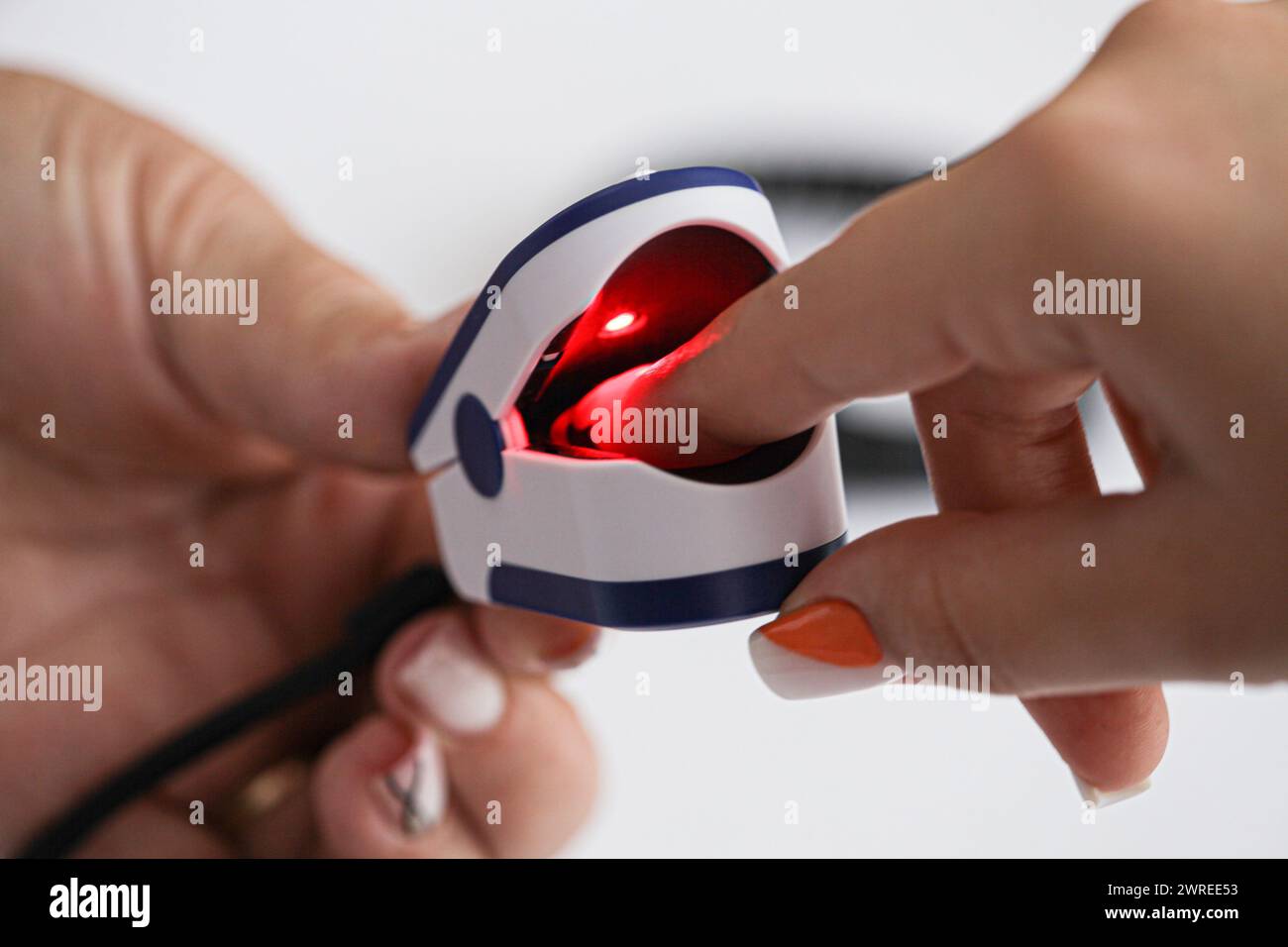 Close up photo of oxygen pressure measurement. Female hands of a doctor ...