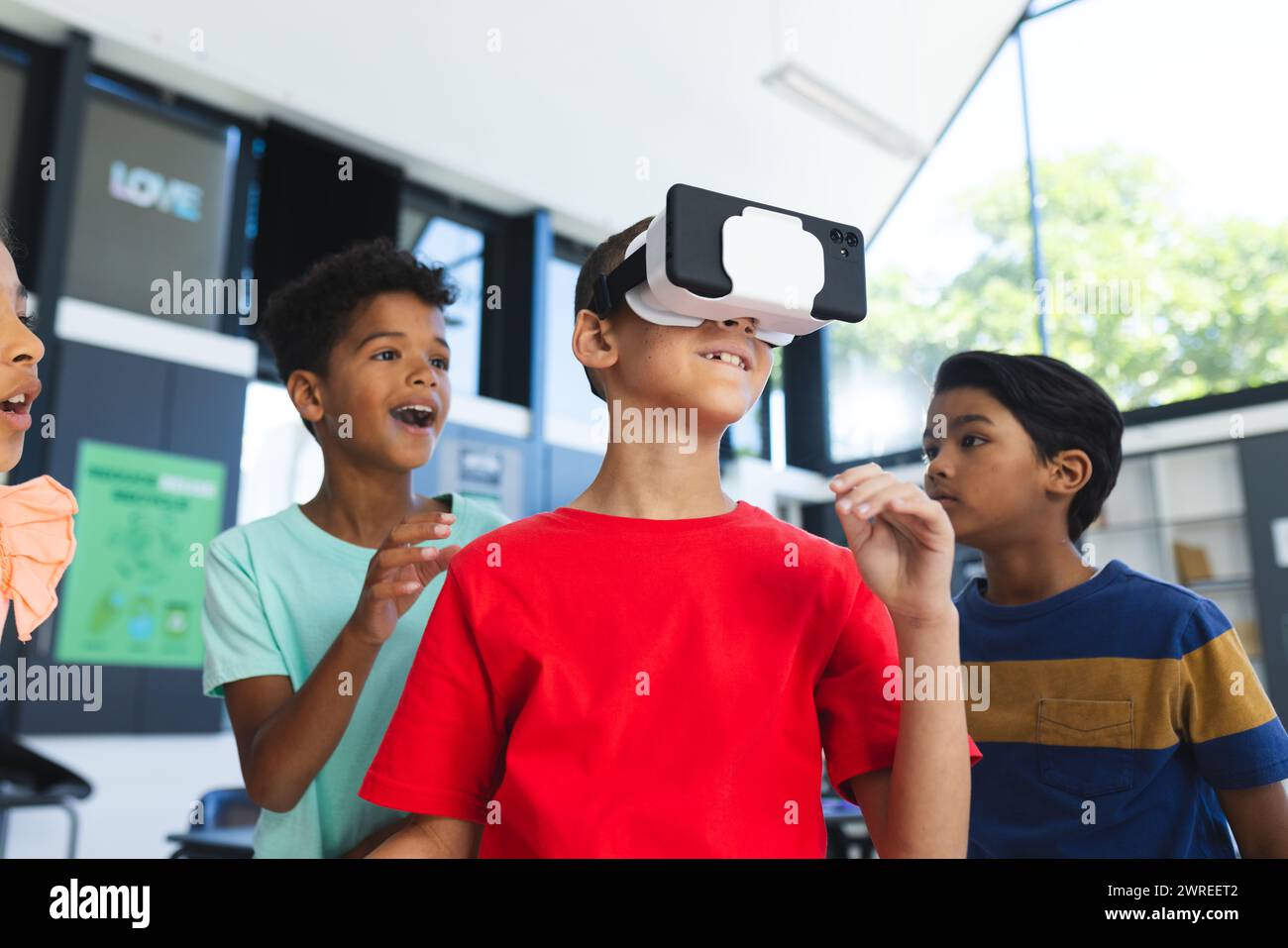 Three biracial boys are exploring virtual reality in the classroom at ...