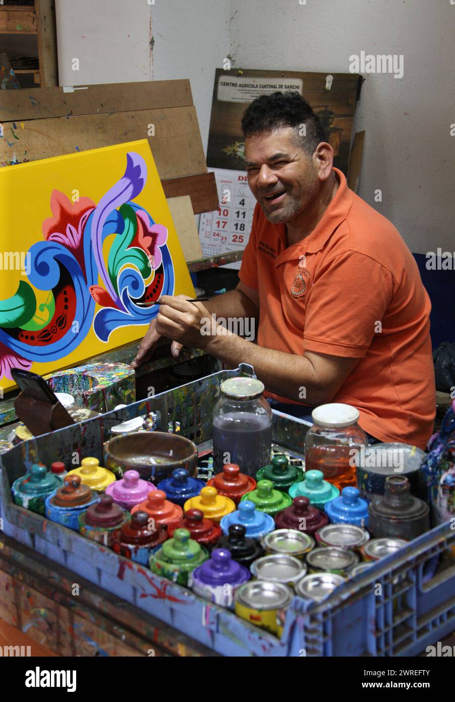 Artist painting designs for ox carts, Sarchi, Central Highlands, Costa ...