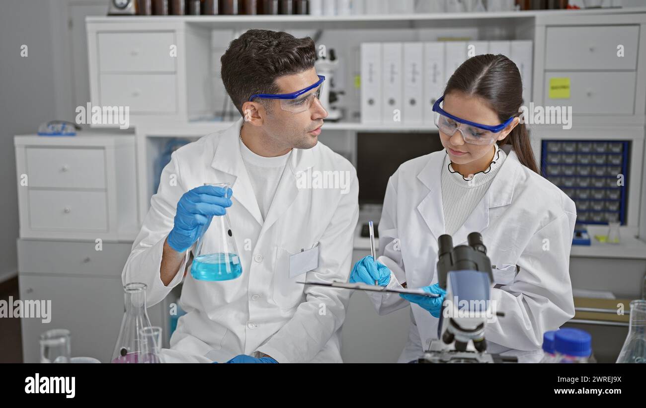 Scientists mixing solutions in laboratory hi-res stock photography and images - Alamy