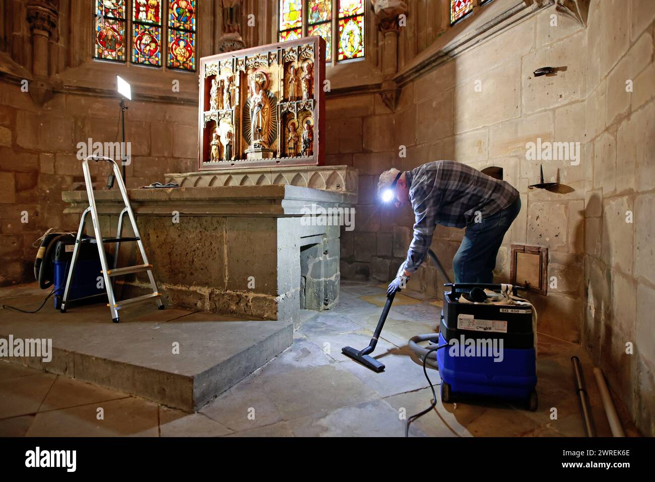 12 March 2024, Saxony-Anhalt, Halberstadt: A cathedral employee cleans ...