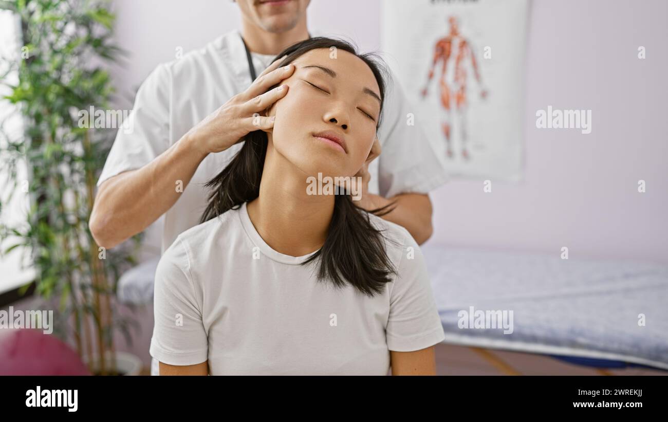 A male therapist performs neck therapy on a relaxed woman in a white ...
