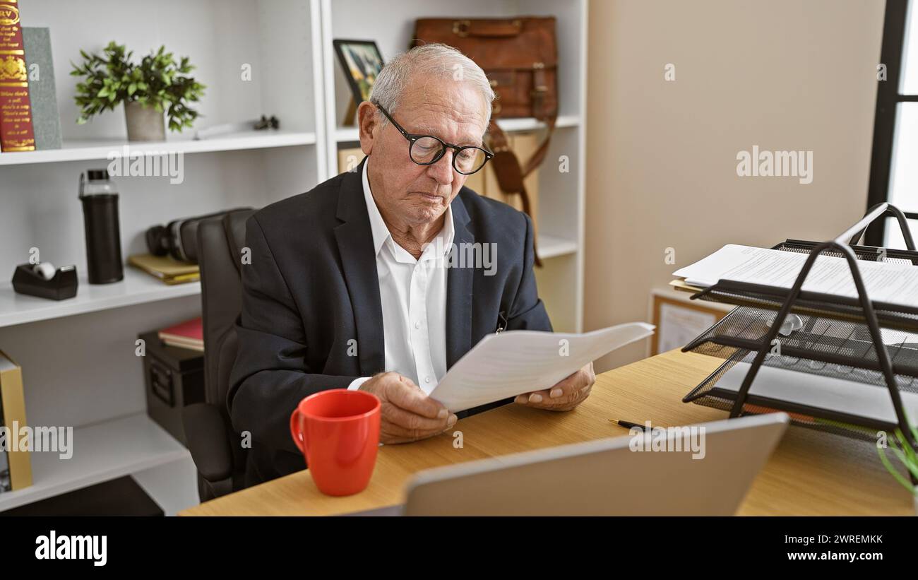 Senior man reading report desk hi-res stock photography and images - Alamy