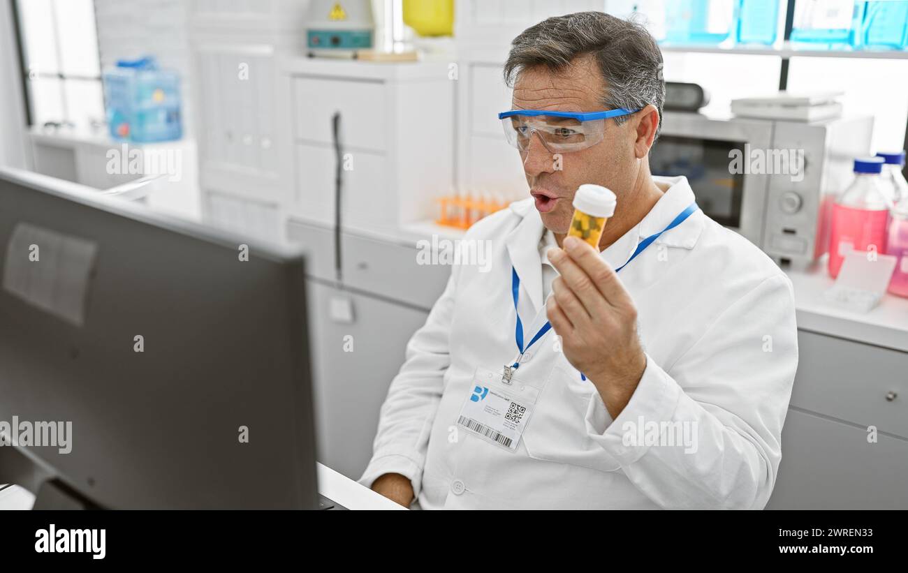 Middle-aged man in lab coat examining a specimen in a medical ...