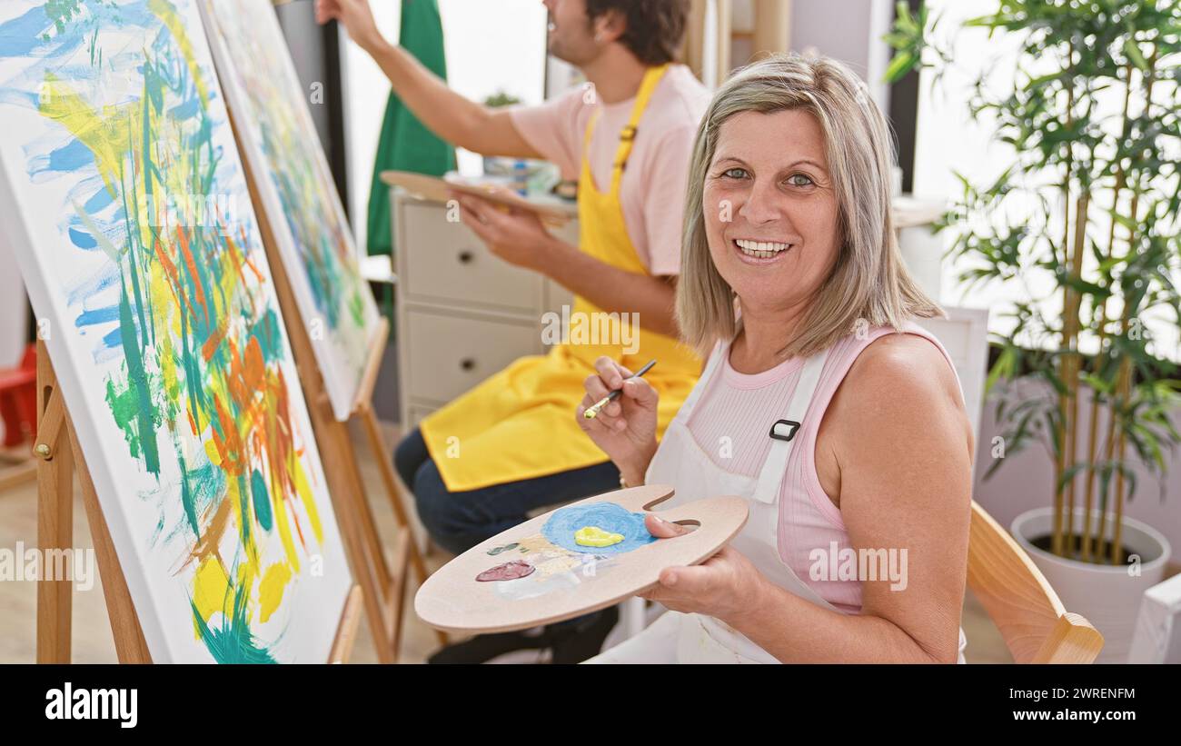 Two confident artists, man and woman, enjoy drawing together with ...