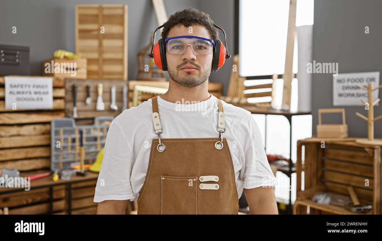 Young man in safety gear standing confidently in a well-organized ...