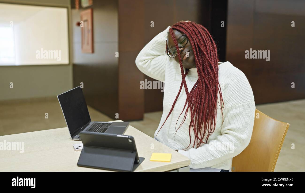 Stressed african american woman with braids feeling overwhelmed in an ...