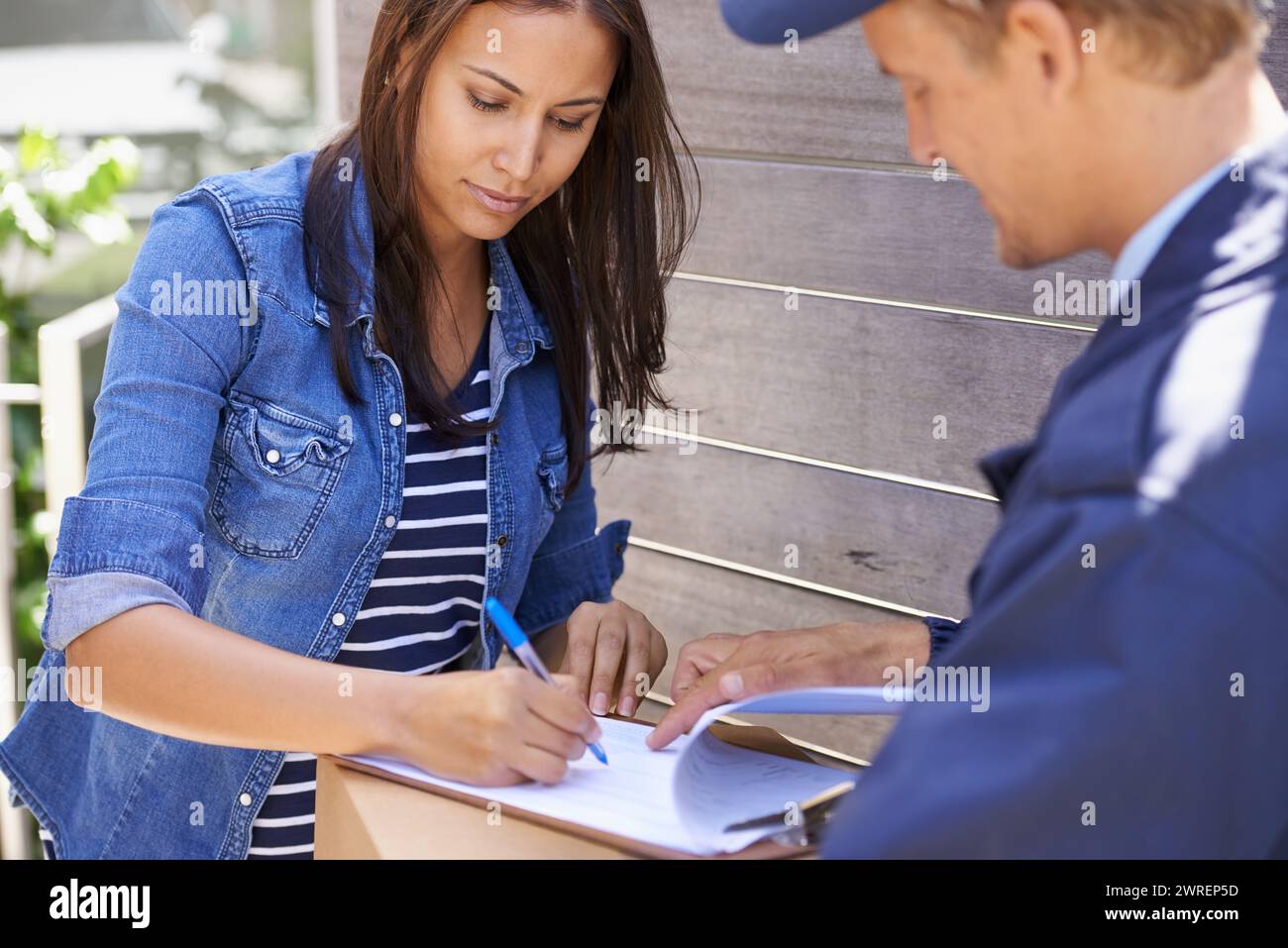 Woman, hands and signature for package, delivery and shipping order ...
