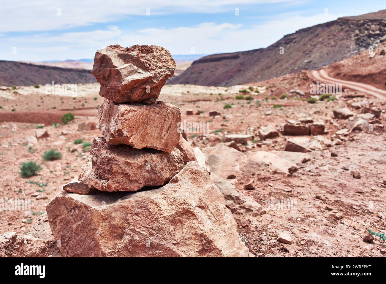 A balanced stack of rocks stands prominently in a serene desert ...