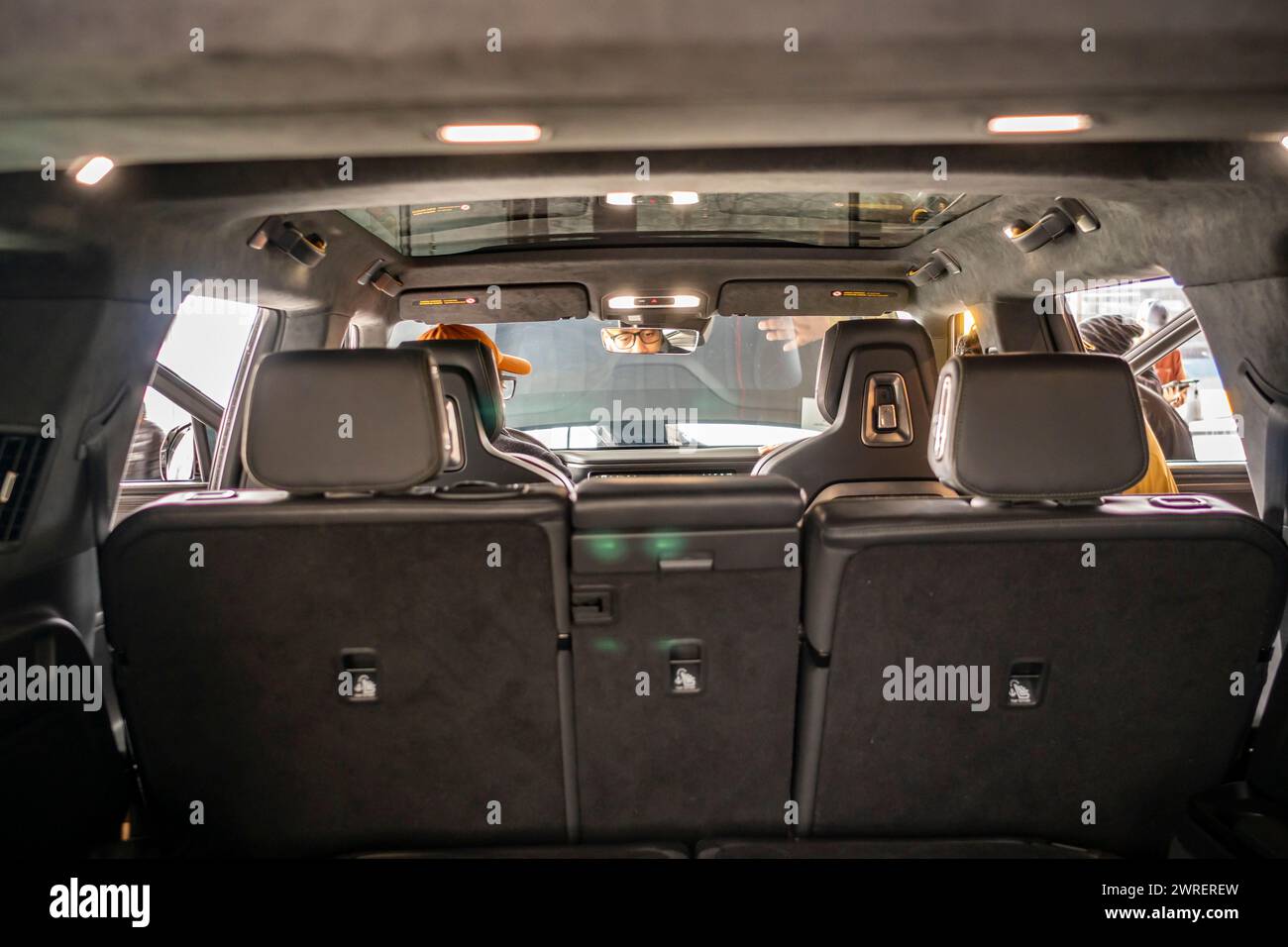 Automobile enthusiasts admire the electric Rivian R1S at an ...