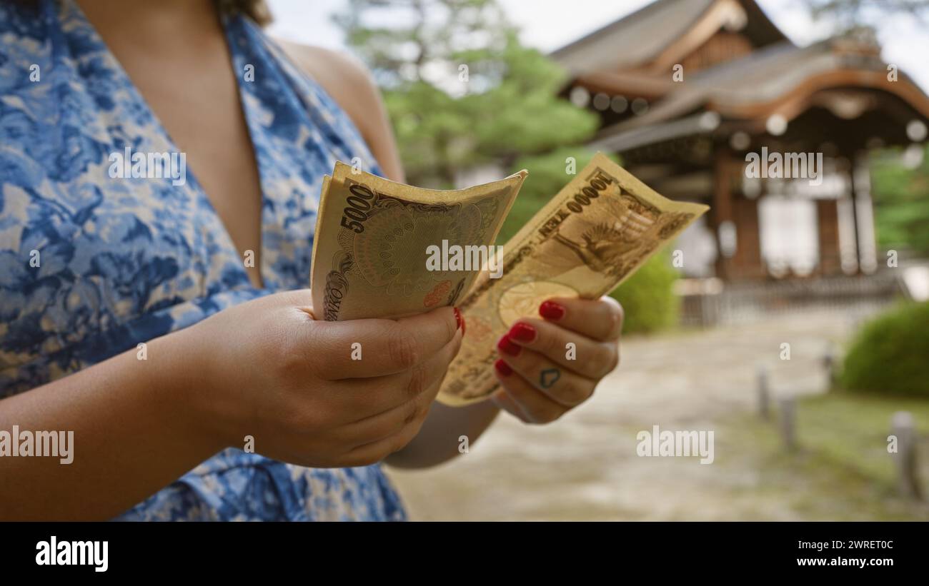 Caucasian young woman's hands counting wealth of japan yen banknotes at ...