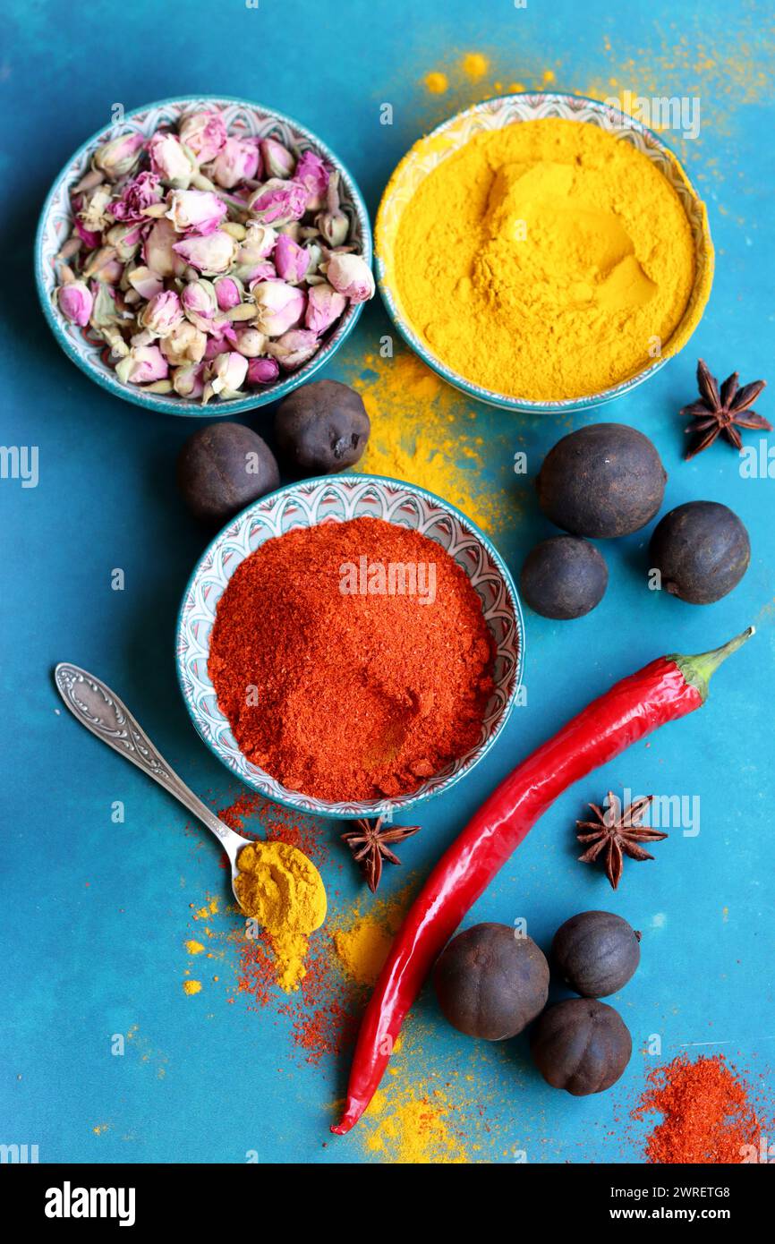 Still life with different spices on blue background with copy space ...