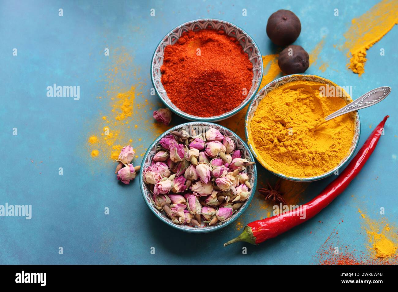 Top view photo of various spices on a blue table. Vivid background with ...