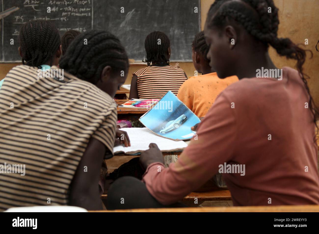 JINKA,ETHIOPIA - NOVEMBER 21, 2011: Children of different age study at ...