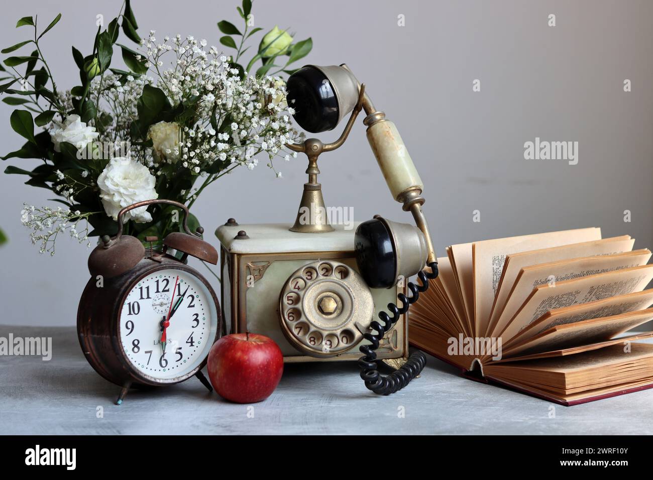 Vintage rotary telephone on a desk. Still life with retro phone. Bright ...