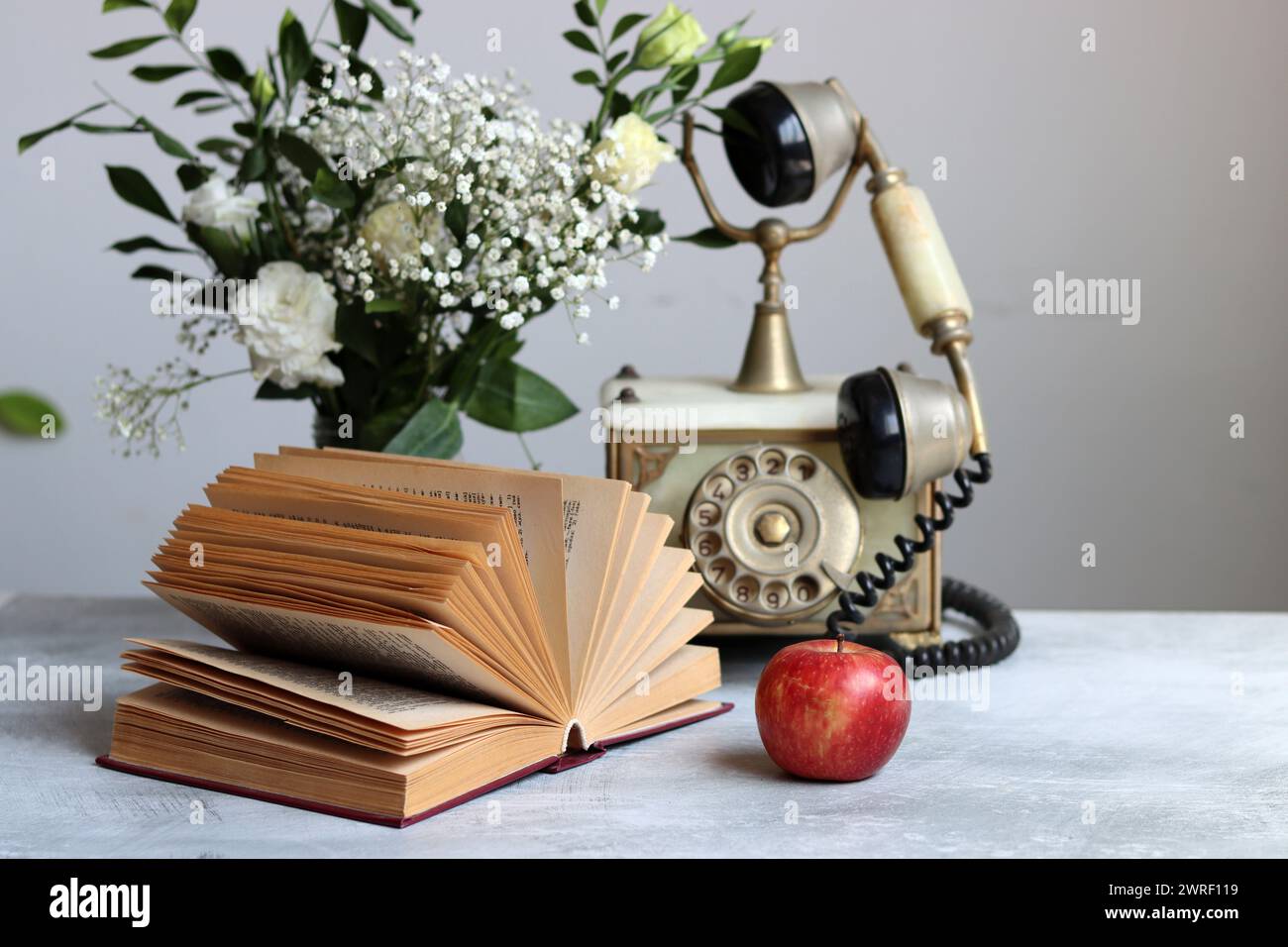 Vintage rotary telephone on a desk. Still life with retro phone. Bright ...