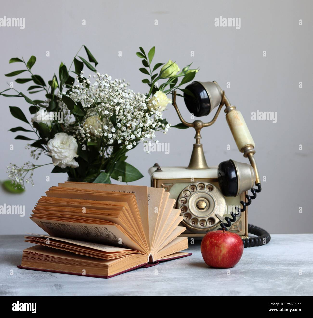 Vintage rotary telephone on a desk. Still life with retro phone. Bright ...