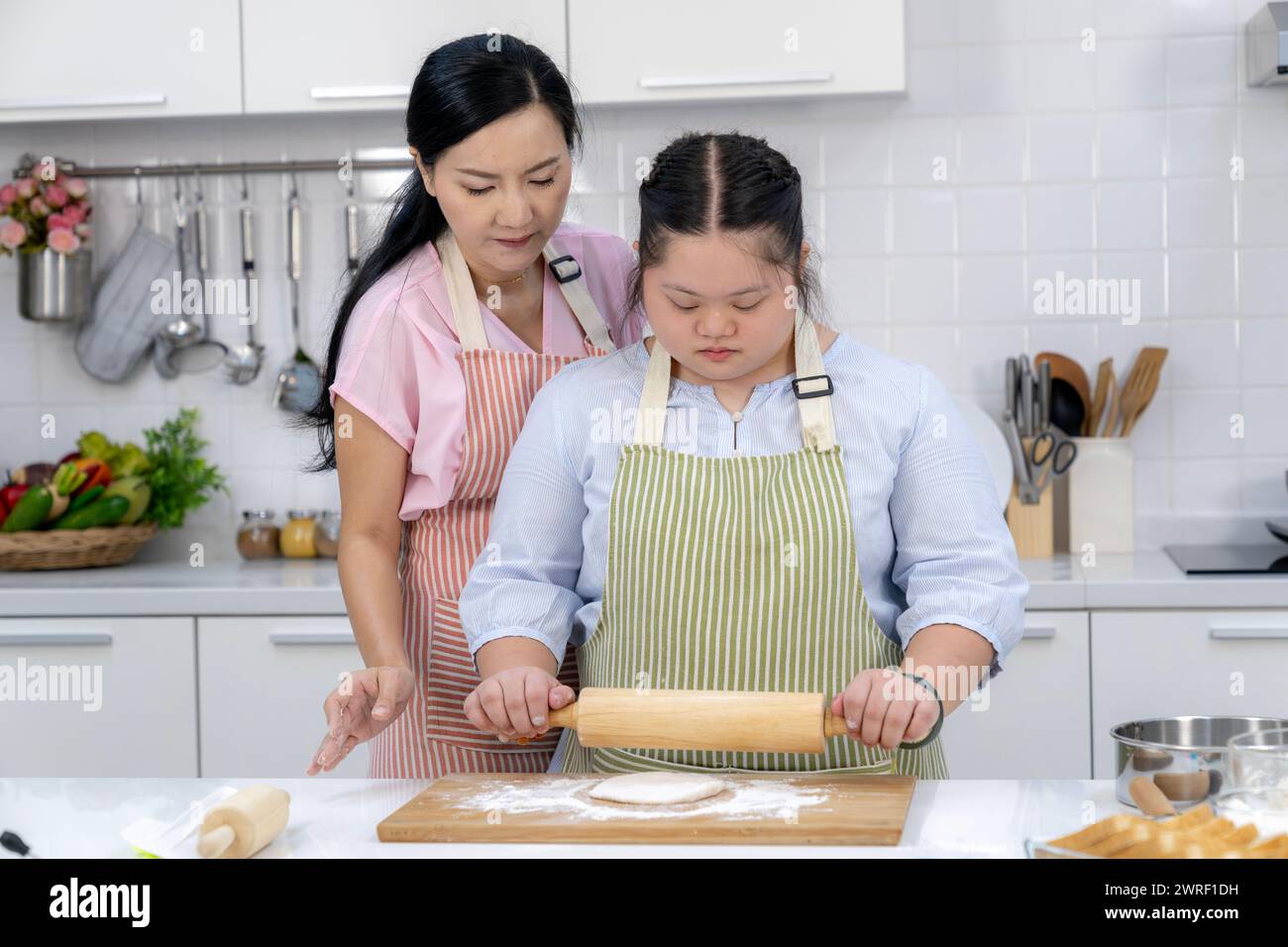 Two girls baking cake in hi-res stock photography and images - Alamy