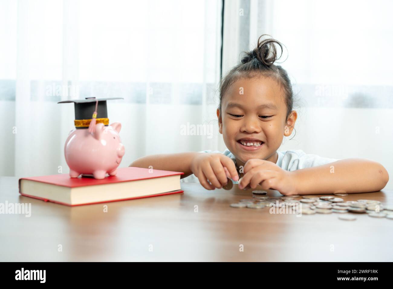 The little child is saving money for education Stock Photo - Alamy