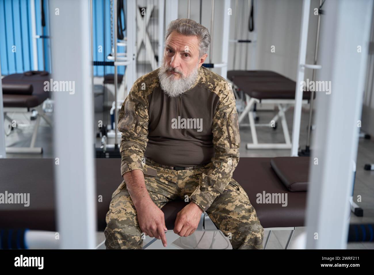 Bearded military man sitting in the gym of rehabilitation center Stock ...