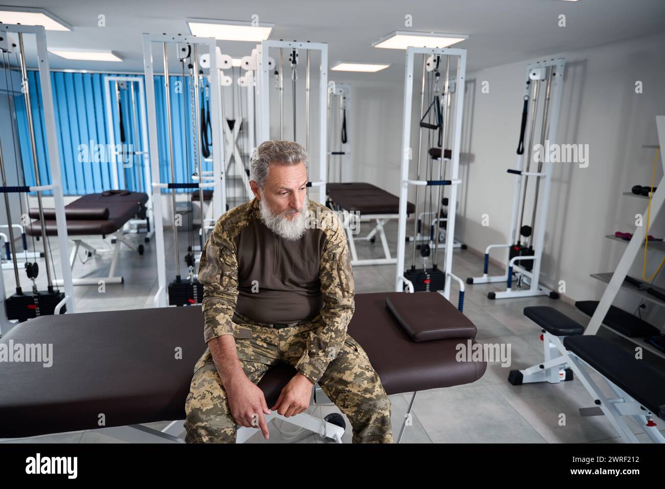 Tired military man sitting in the gym of a rehabilitation center Stock ...
