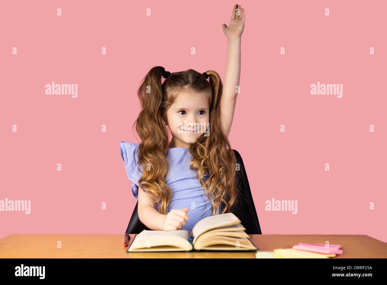 Female student hand up answer hi-res stock photography and images - Alamy