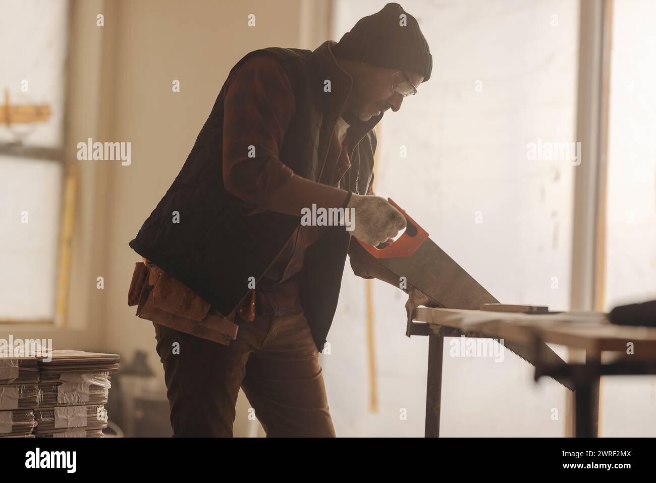 Skilled carpenter performs precise trim work for a kitchen molding ...