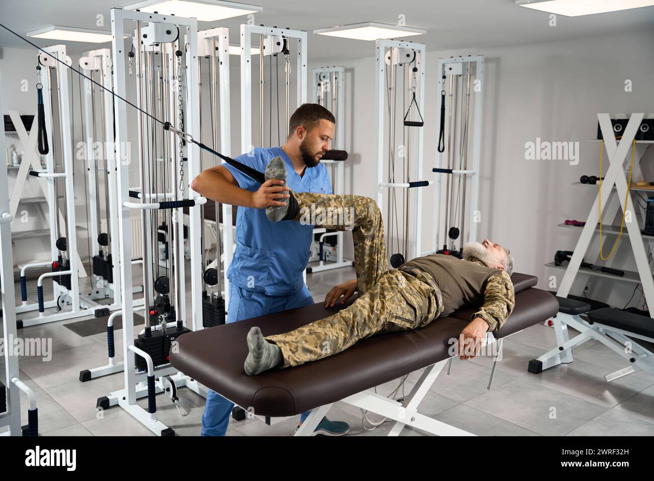 Patient does muscle stretching exercises on a special simulator Stock ...