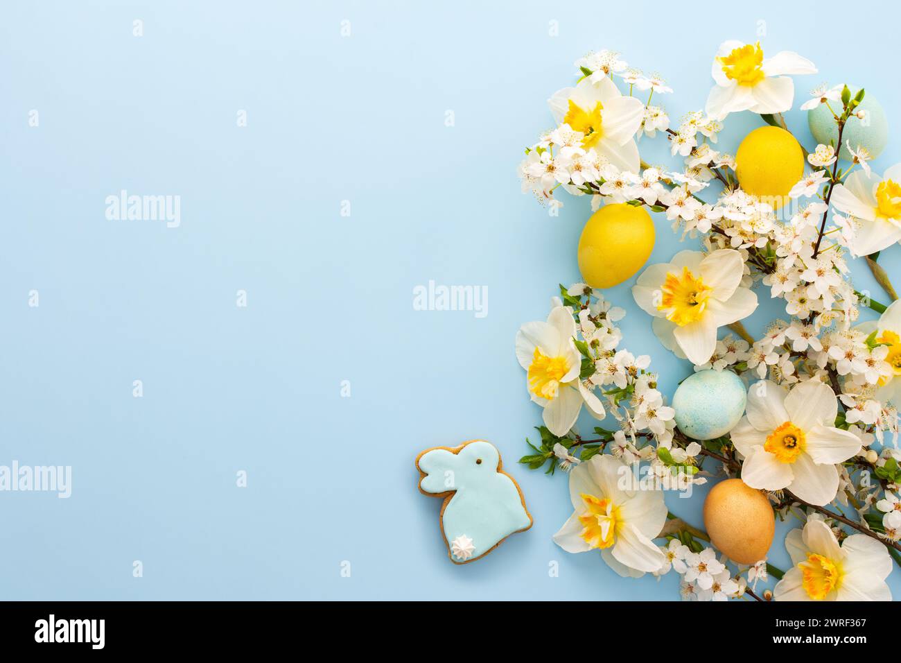 Festive background with spring flowers and naturally colored eggs and ...