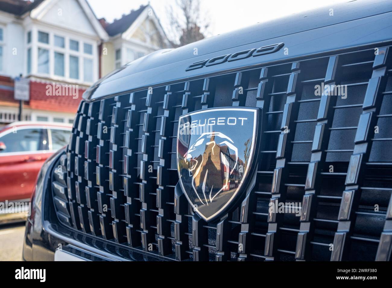 LONDON- FEBRUARY 4, 2024: Peugeot 2008 logo badge on front grill of car ...