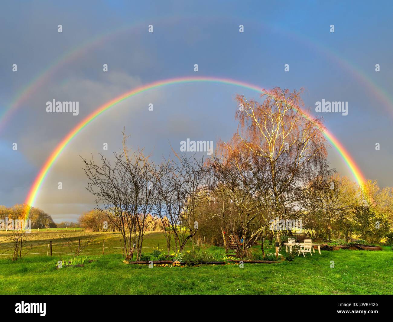 Complete arc of brightly coloured double rainbow after storm - central ...