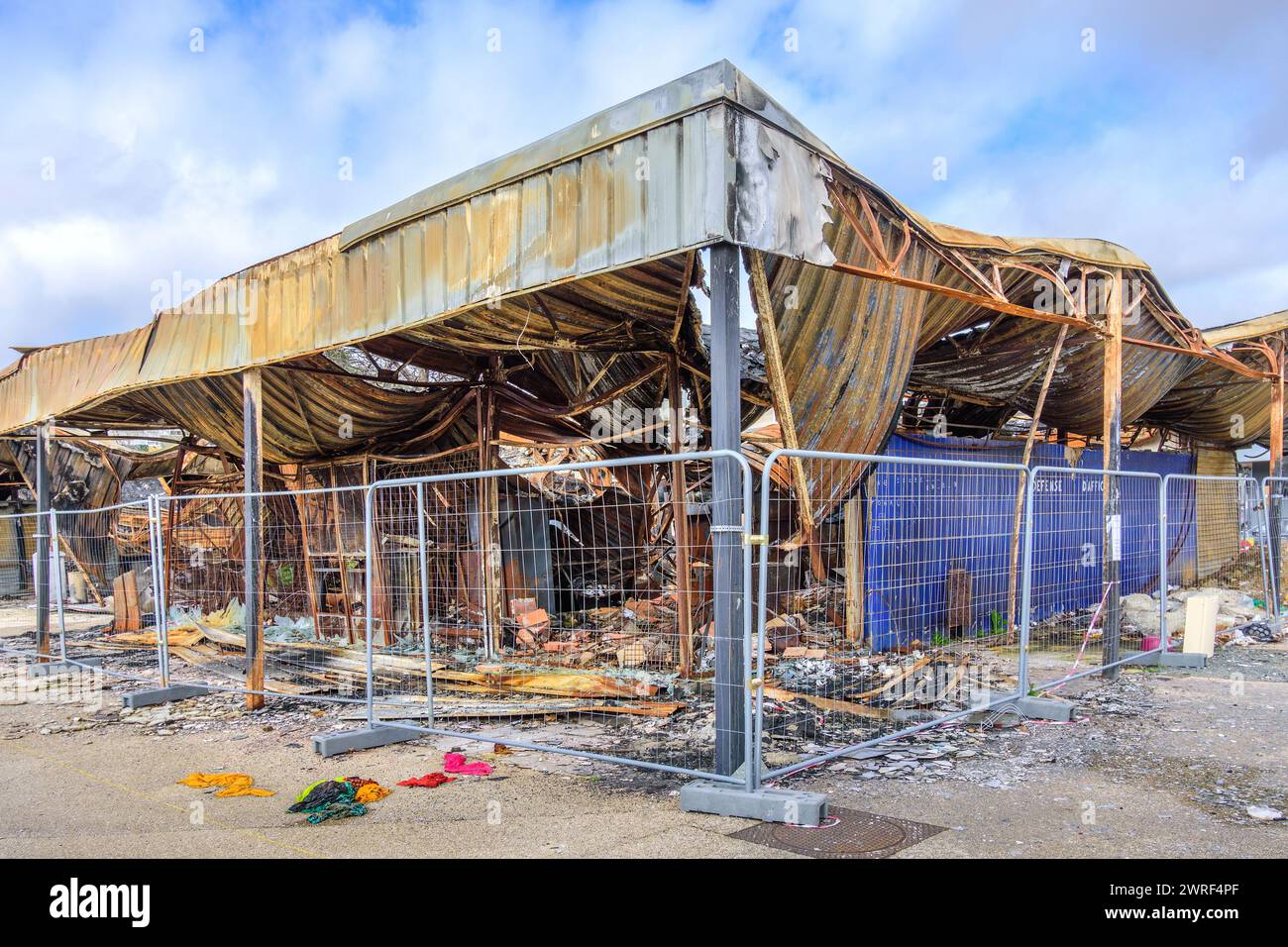 Burnt-out remains of small shops and commercial premises after arson ...