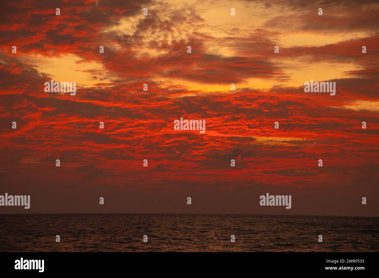 stunningly beautiful bright red dramatic sunset sky over indian ocean ...