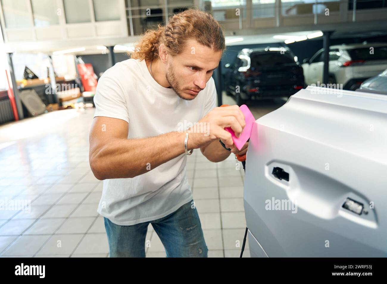 Master uses an industrial dryer when detailing a car Stock Photo - Alamy