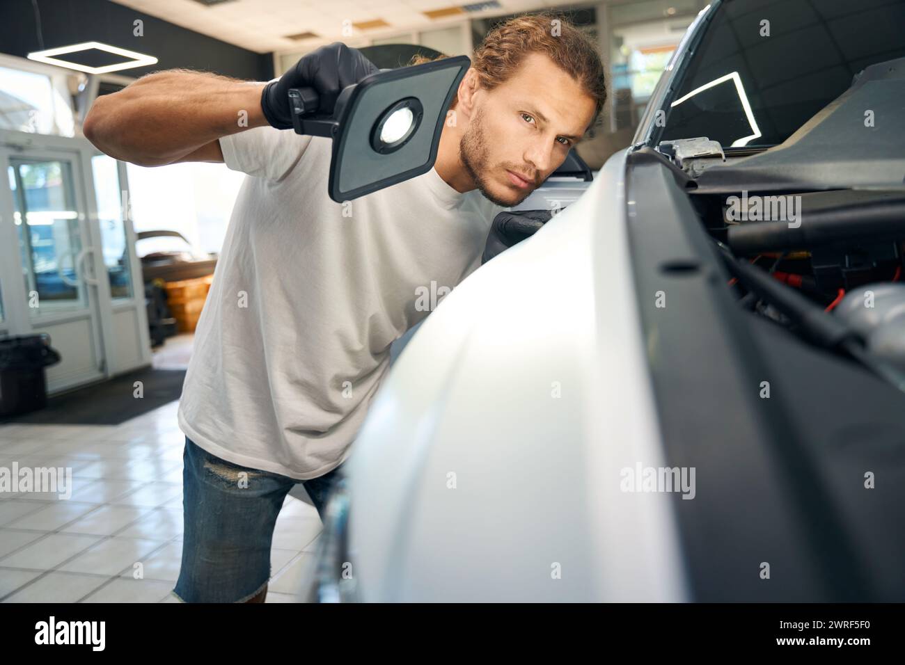 Male conducts a control inspection of the car body Stock Photo - Alamy
