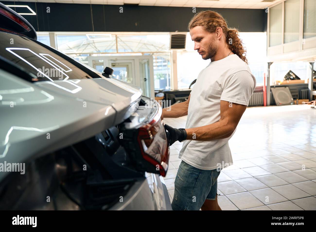 Car detailing specialist installing hi-res stock photography and images ...