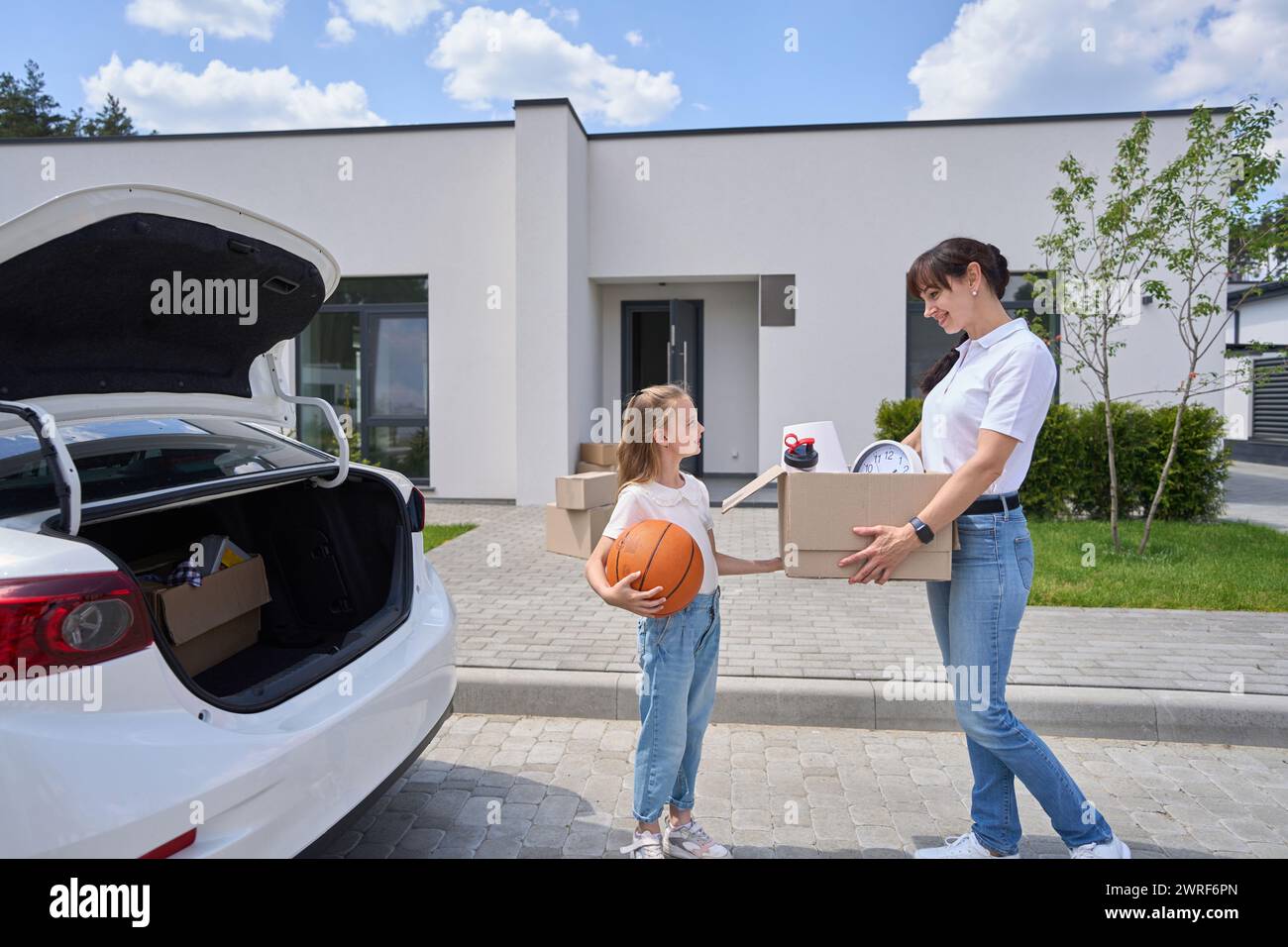 Mother daughter smiling packing hi-res stock photography and images - Alamy