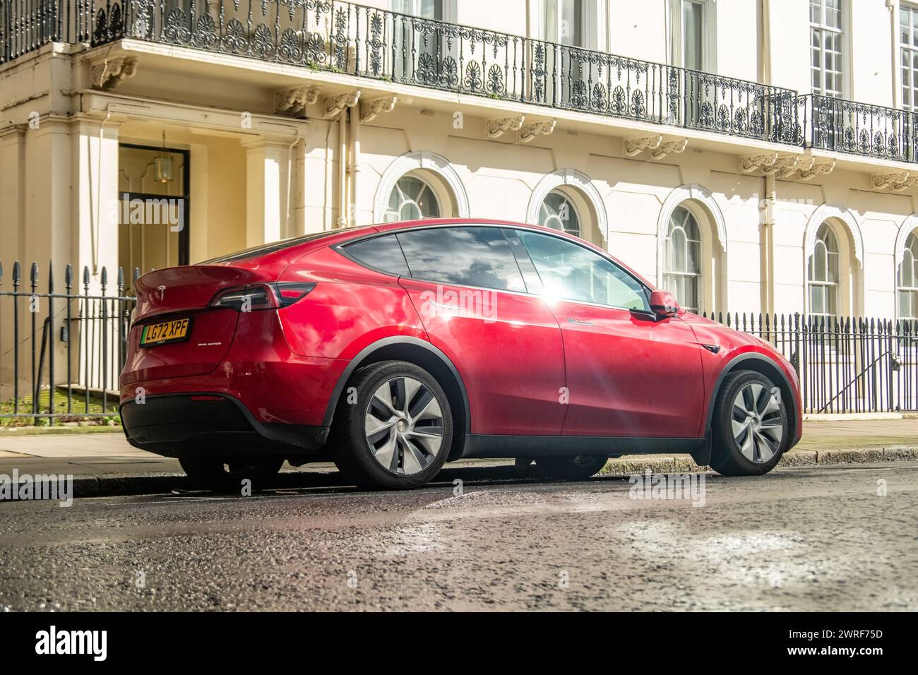 LONDON- FEBRUARY 19, 2024: Tesla Model 3 parked on upmarket residential ...