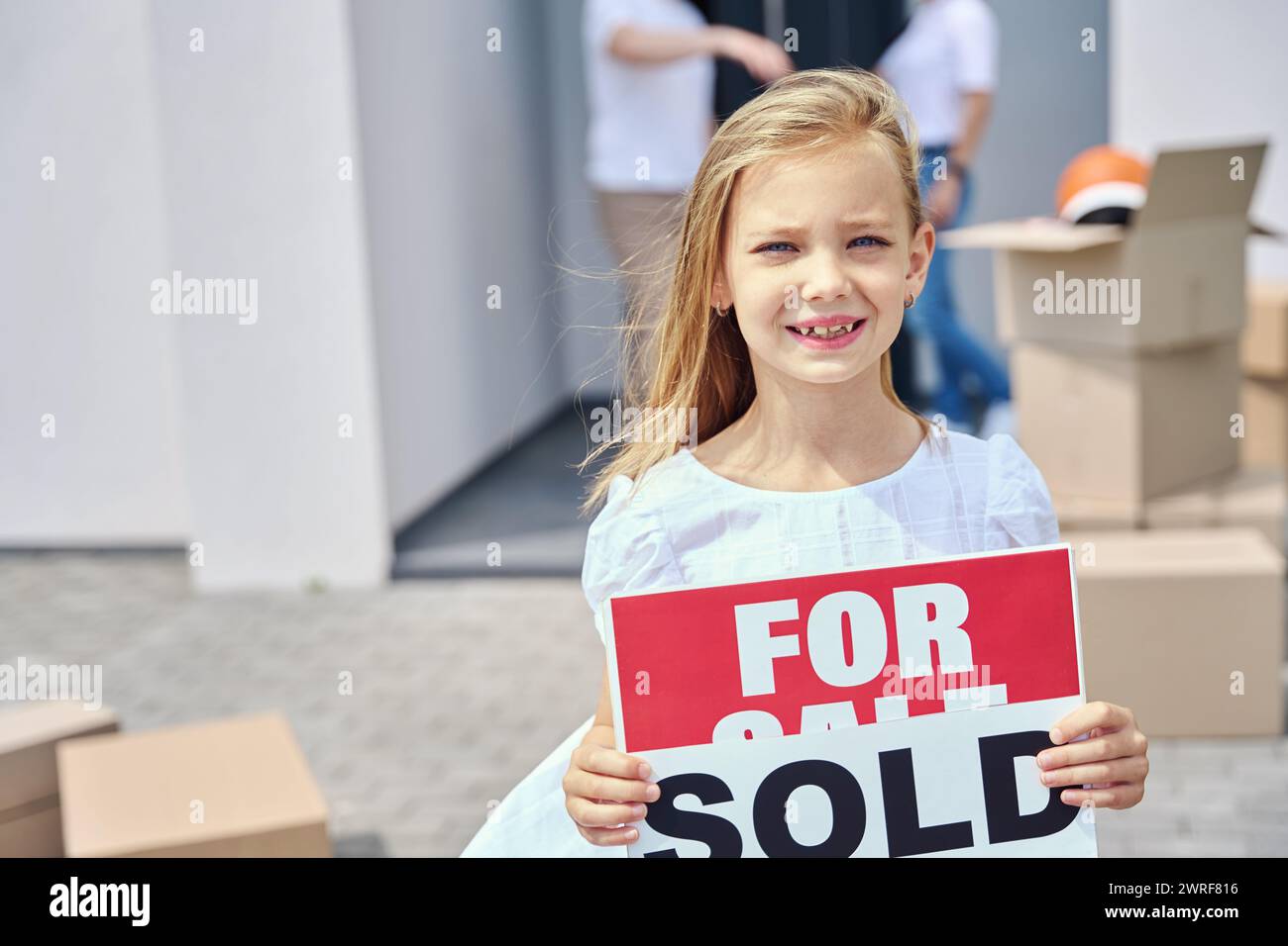 Cute girl stands in yard with signs for sale, sold Stock Photo - Alamy