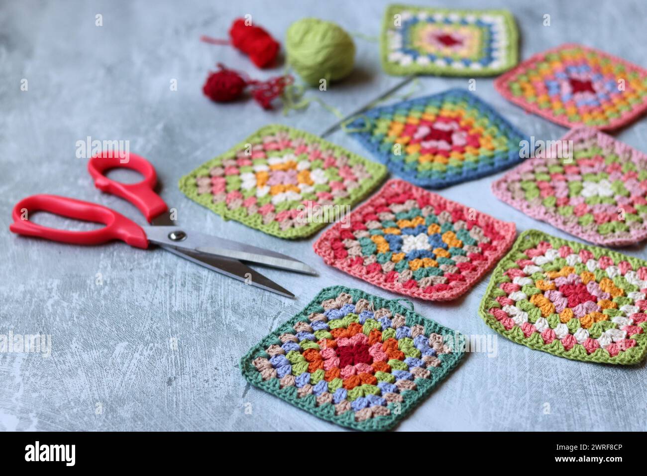 Crochet project in making. Colorful crochet squares close up photo ...