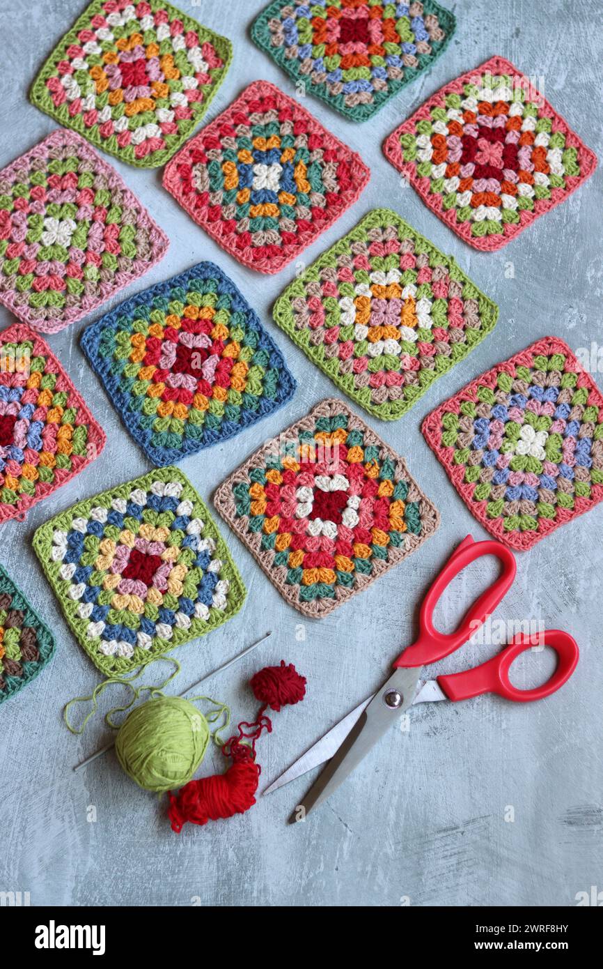 Handmade crocheting, needlework and handicraft concept. Rainbow colored ...